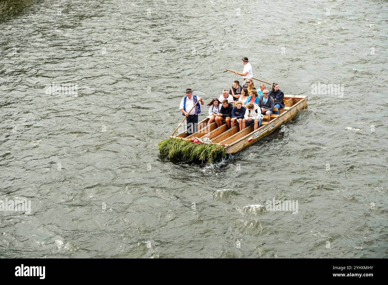 Senior tourists enjoying a trip on traditional wooden rafts on the ...