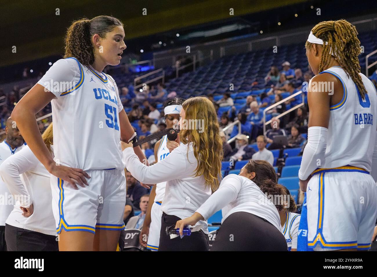 UCLA center Lauren Betts (51) is attended to by athletic trainer Alexa ...