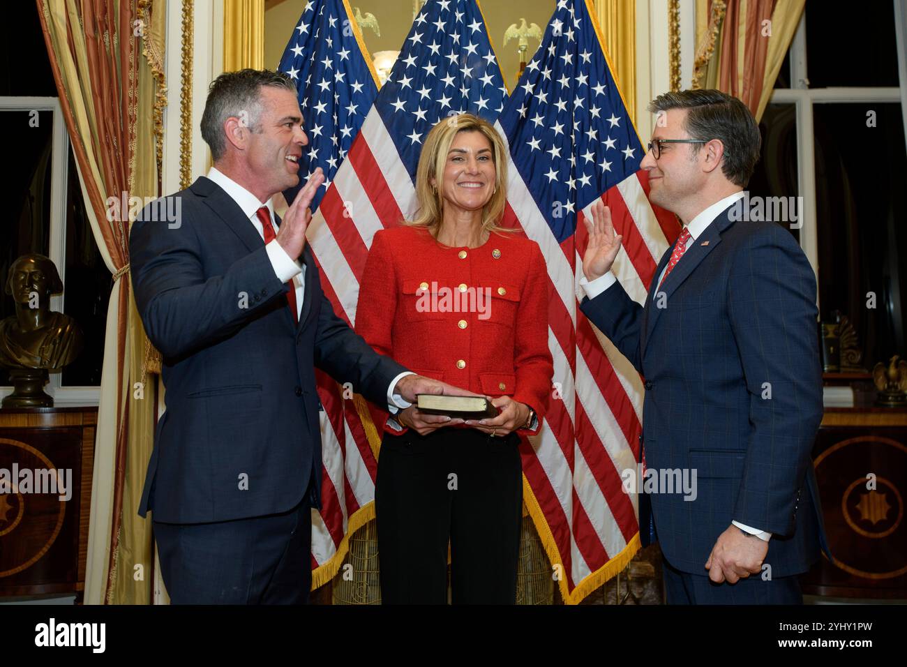 Speaker of the House Mike Johnson, R-La., right, holds a ceremonial ...