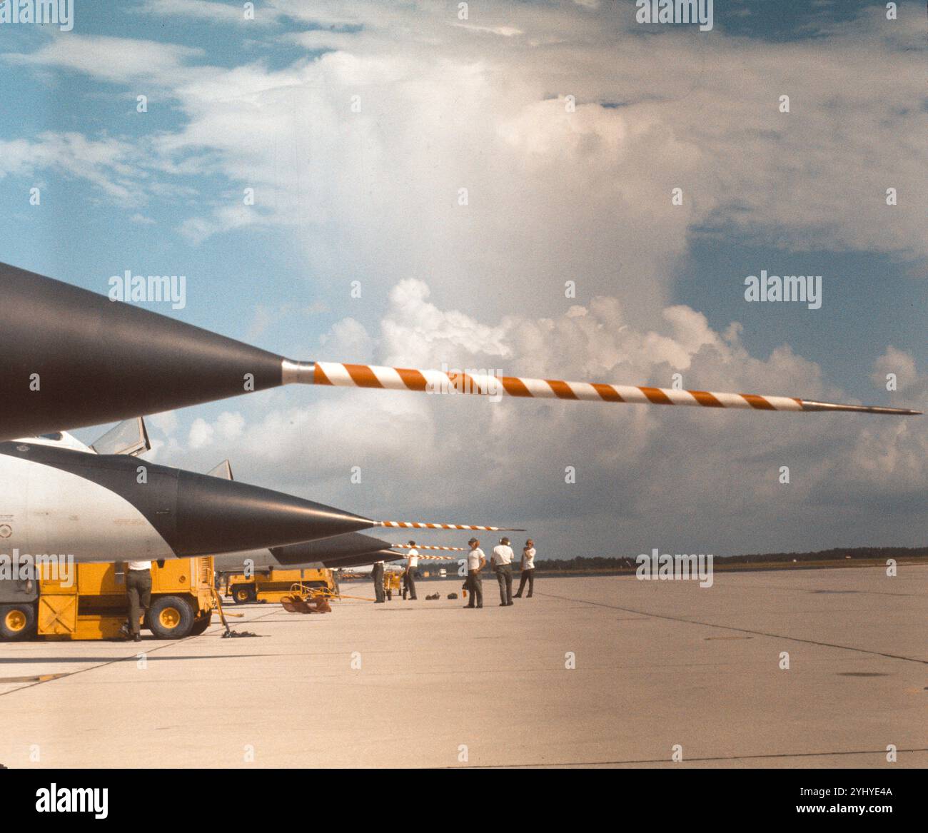 Framed by candy stripe painted F-106A pitot boom, 318th FIS crew chiefs ...