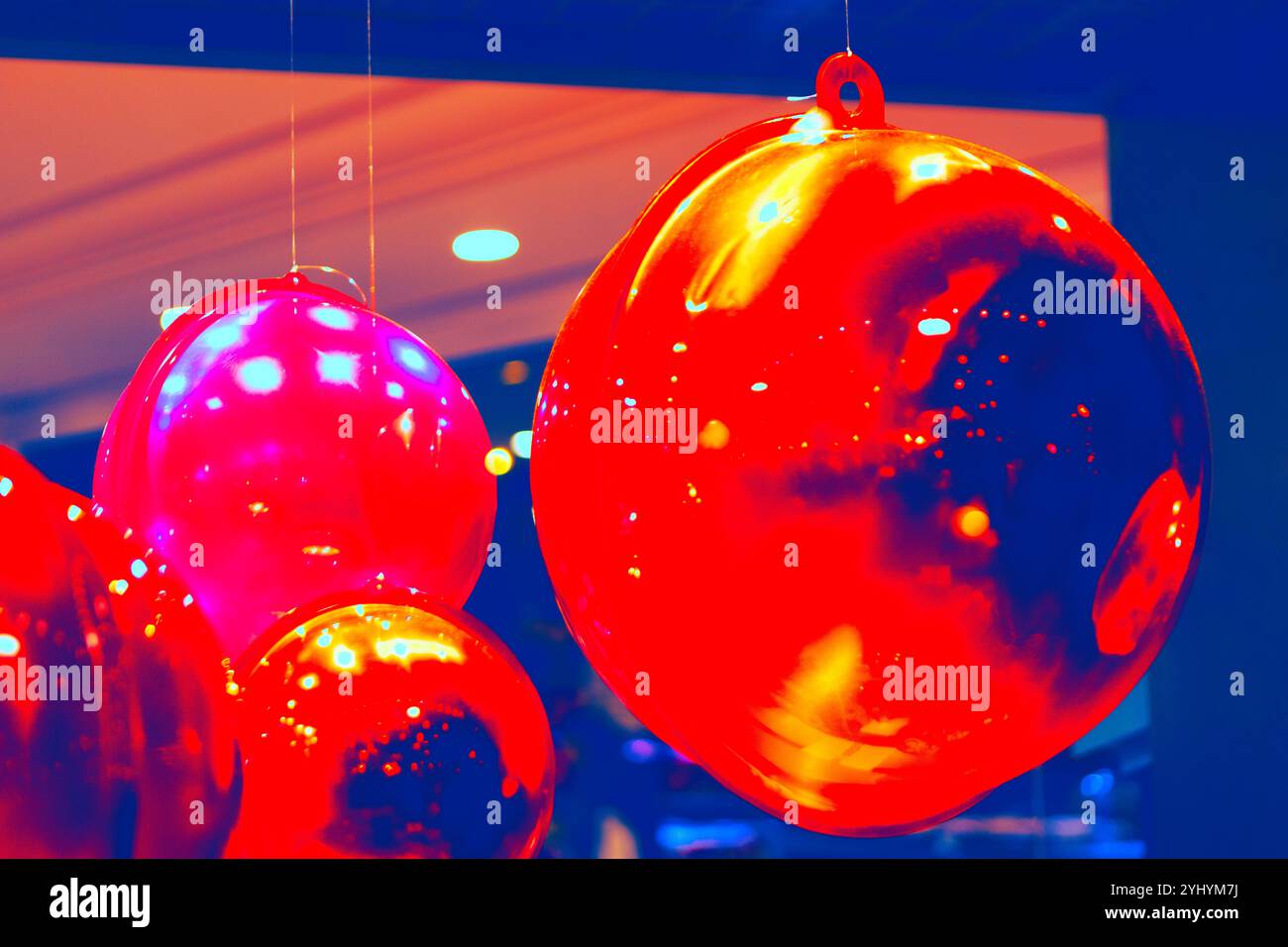 Christmas vibrant red balloons suspended from a ceiling, creating a ...