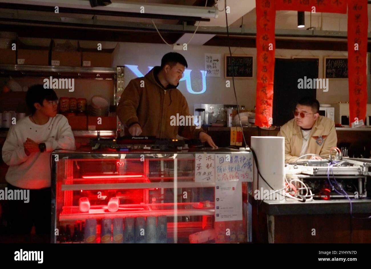 Xing Long, a DJ and rave organizer, tests audio gear ahead of a rave at ...