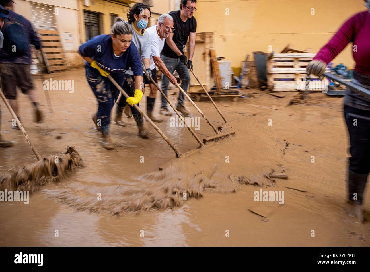 Volunteers cleaning a street in Paiporta, Valencia, Spain, in the ...