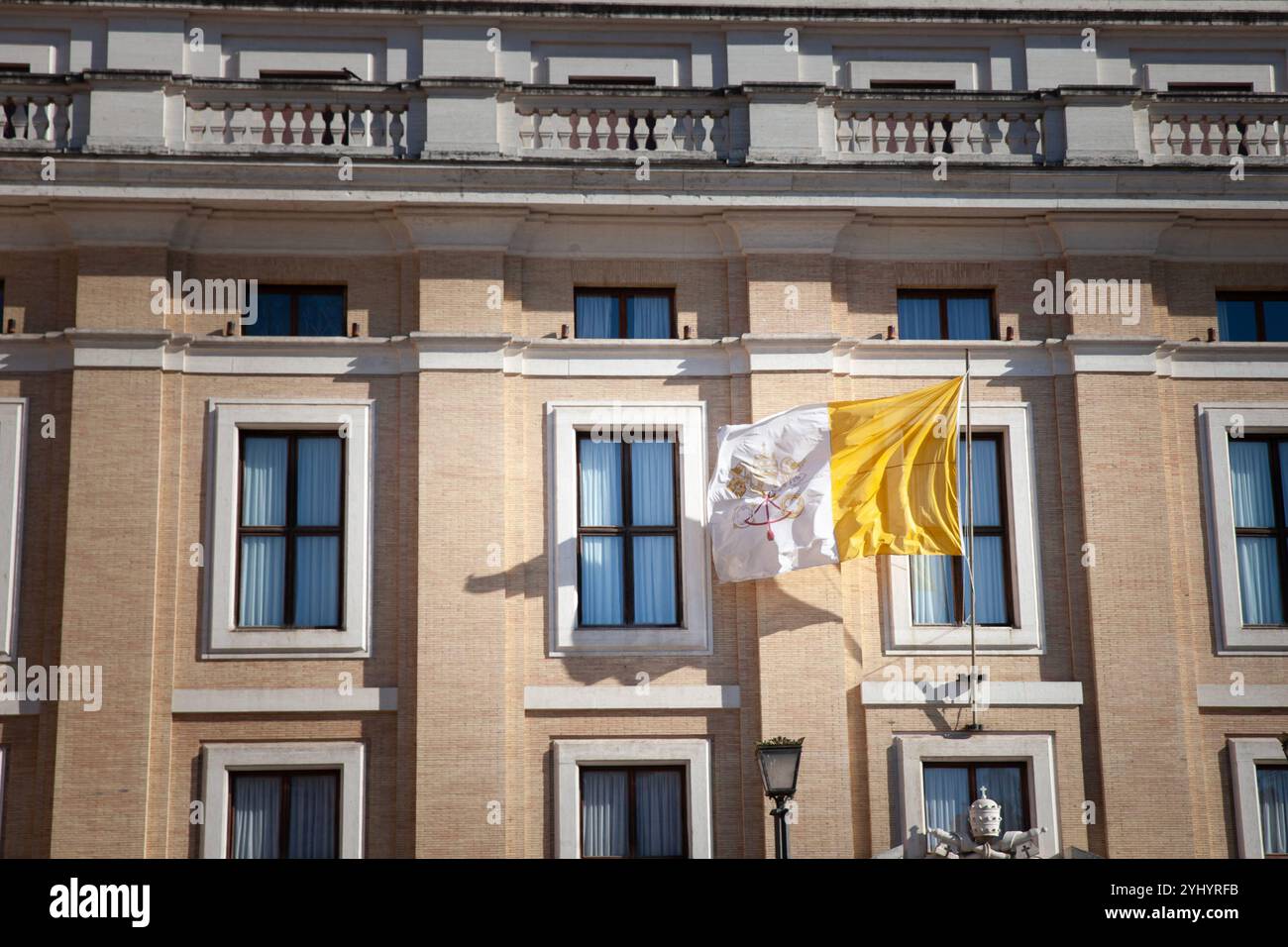 The flag of the Vatican waves in Vatican City, symbolizing the Holy See ...