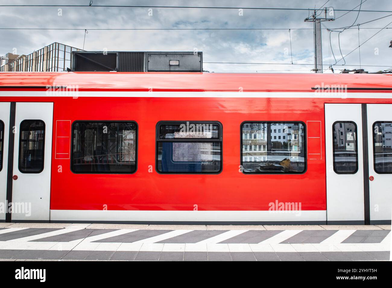 A German S-Bahn train at a suburban station platform, highlighting the ...