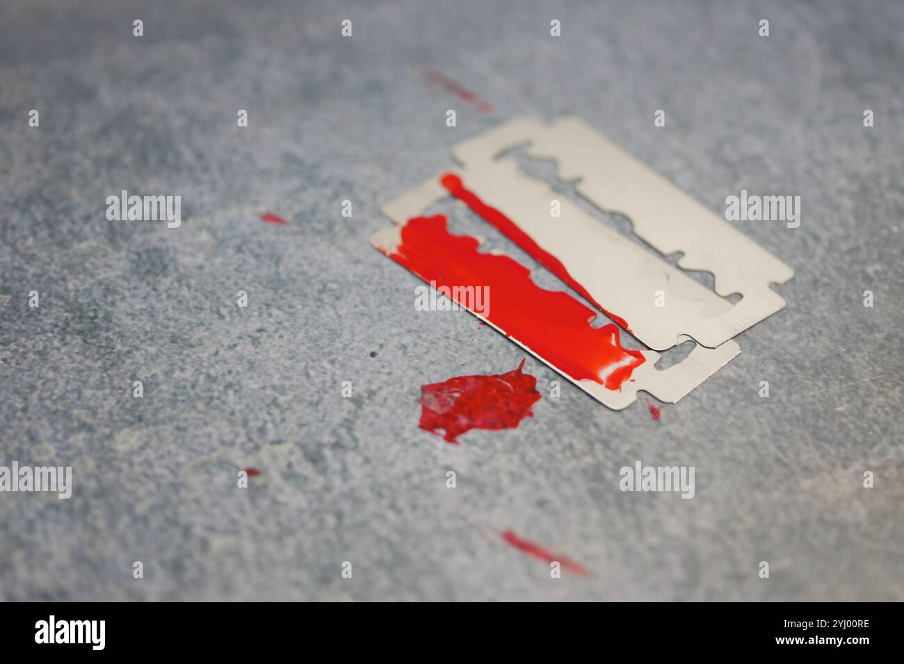 Razor Blades with blood on Concrete Surface Stock Photo - Alamy