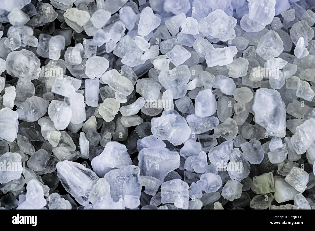 High contrast black and white macro photo of scattered coarse salt ...