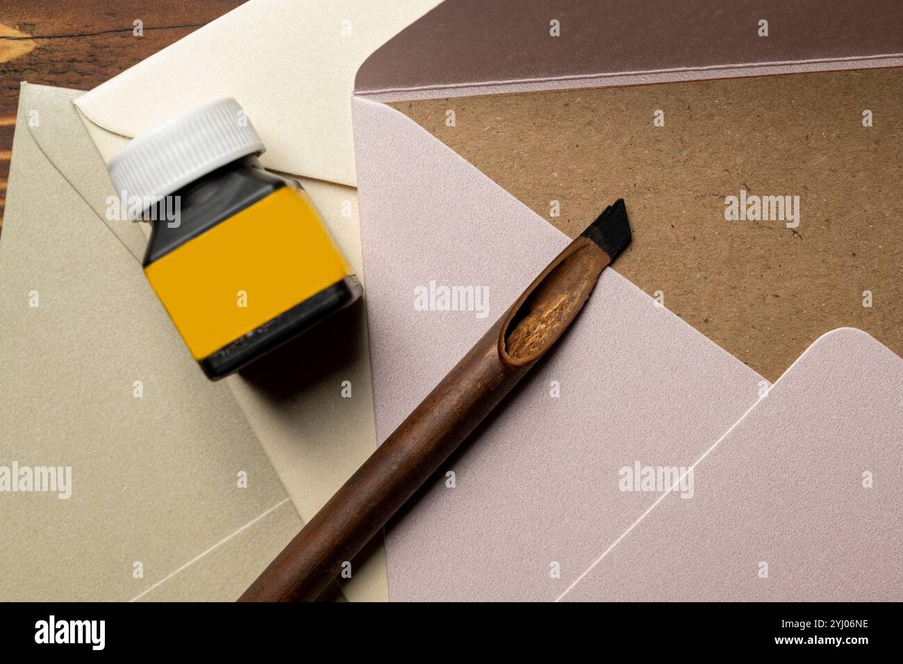 Calligraphy reeds covered ink with inkwell and stack of envelopes and ...