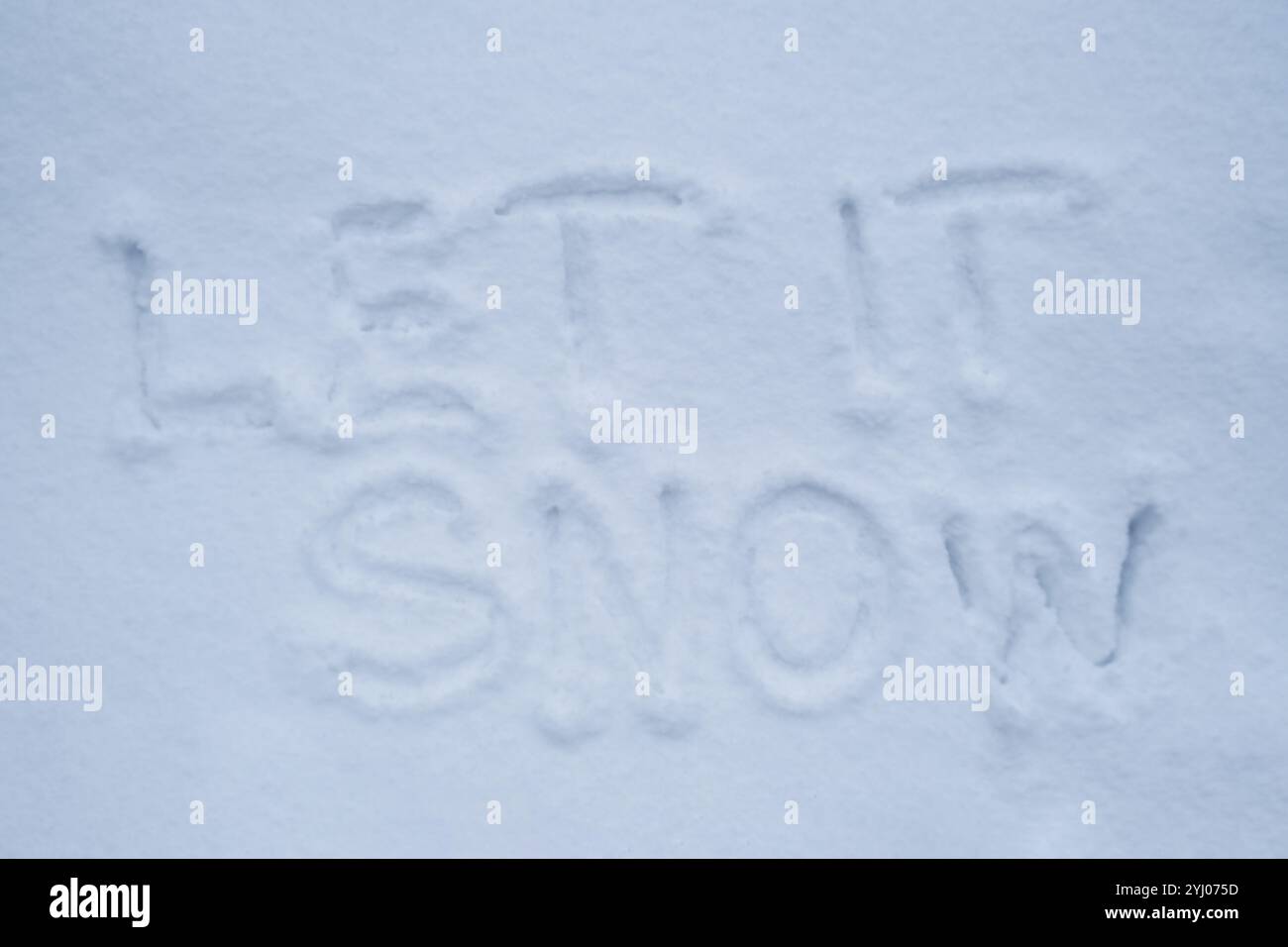 LET IT SNOW text handwritten in snowy winter season surface. Freezing ...