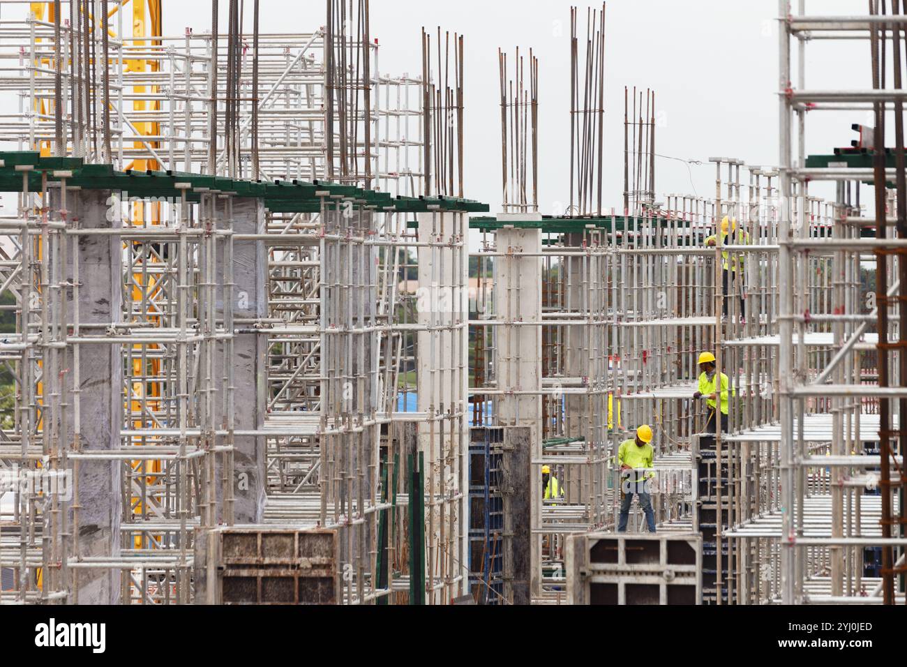 asian construction workers working on scaffolding of building ...
