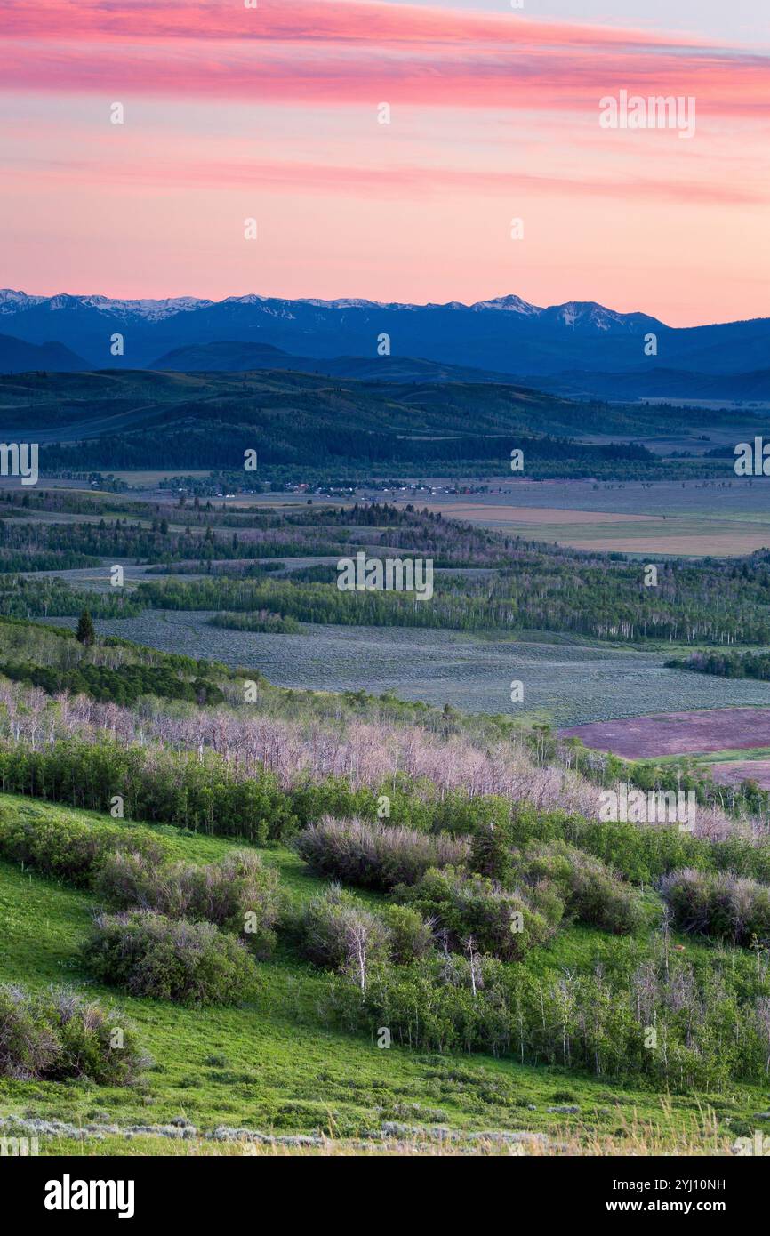 Distant Snake River Mountain peaks rising above the town of Kelly and ...