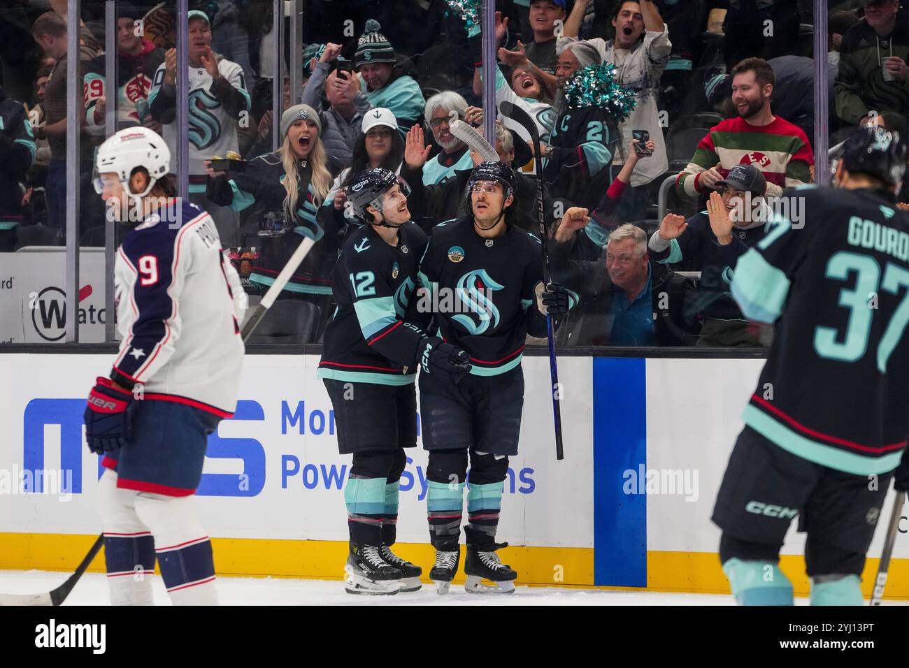 Seattle Kraken left wing Brandon Tanev, third from left, celebrates his ...