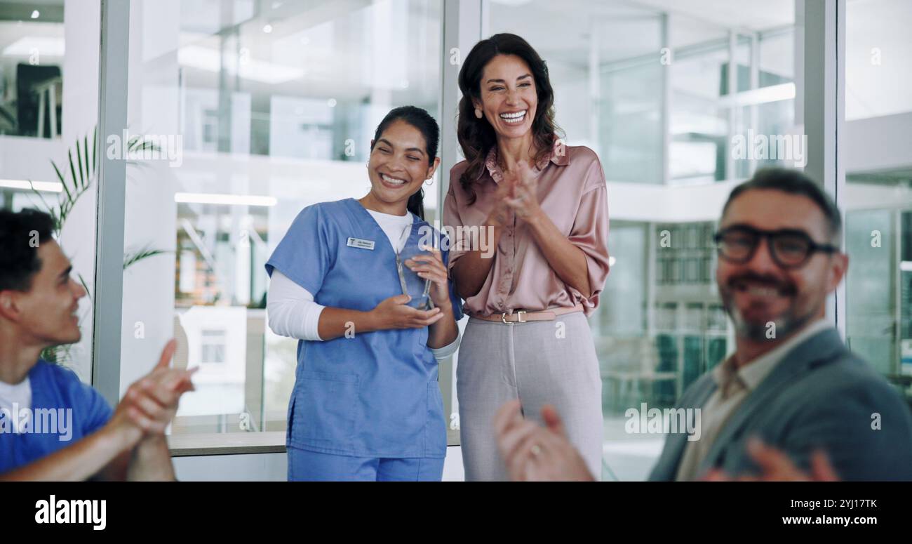 Happy nurse, award and team with applause for congratulations ...