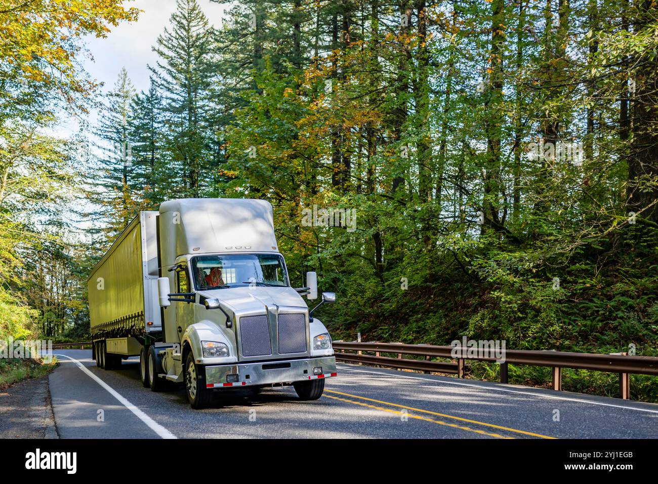 Powerful white day cab big rig semi truck with roof spoiler ...