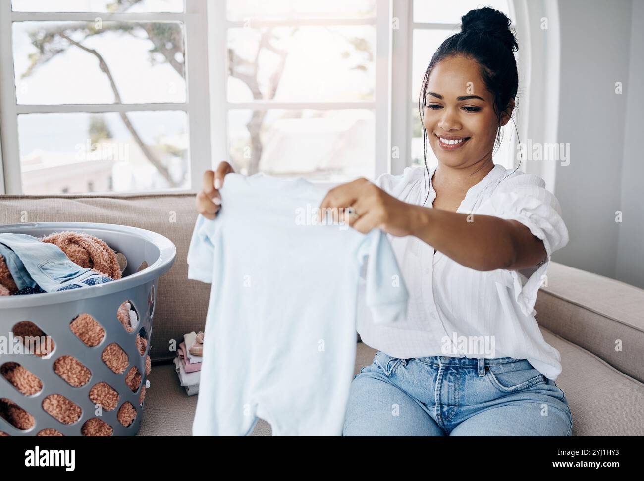 Happy woman, laundry and folding for housekeeping, cleaning service and ...
