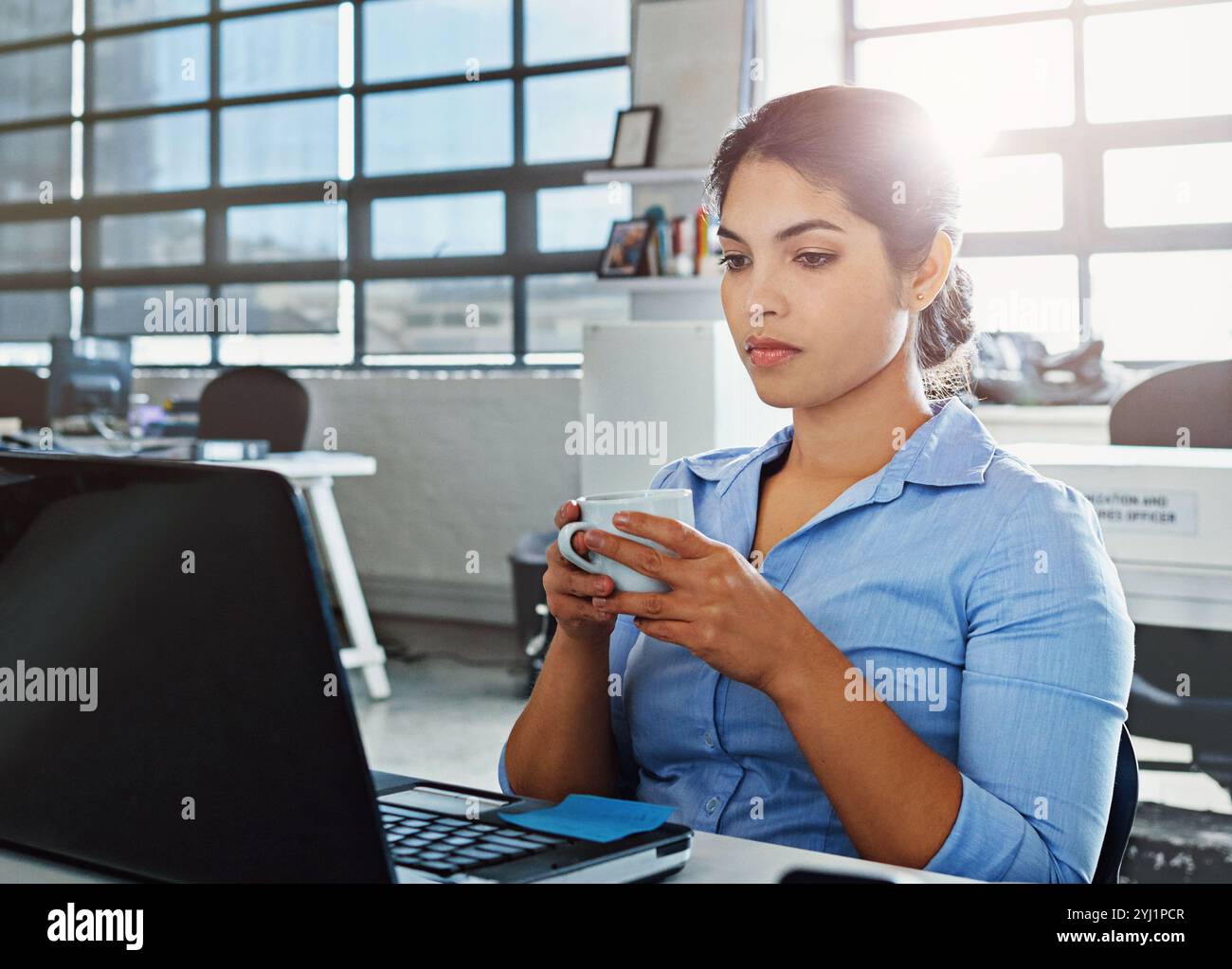 Woman, employee and serious with coffee on laptop for research and ...