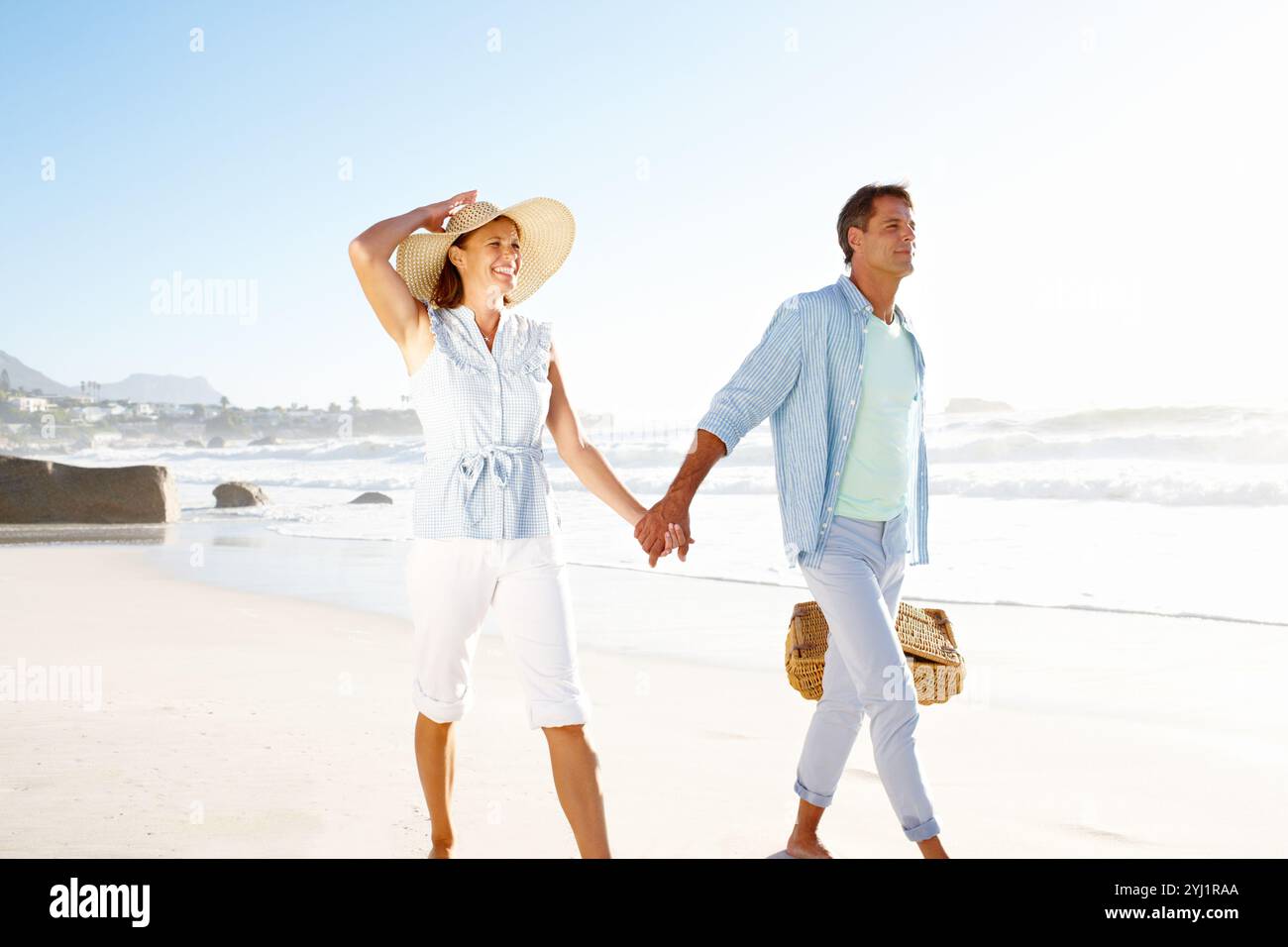 Holding hands, beach and couple with picnic, basket and love for summer ...