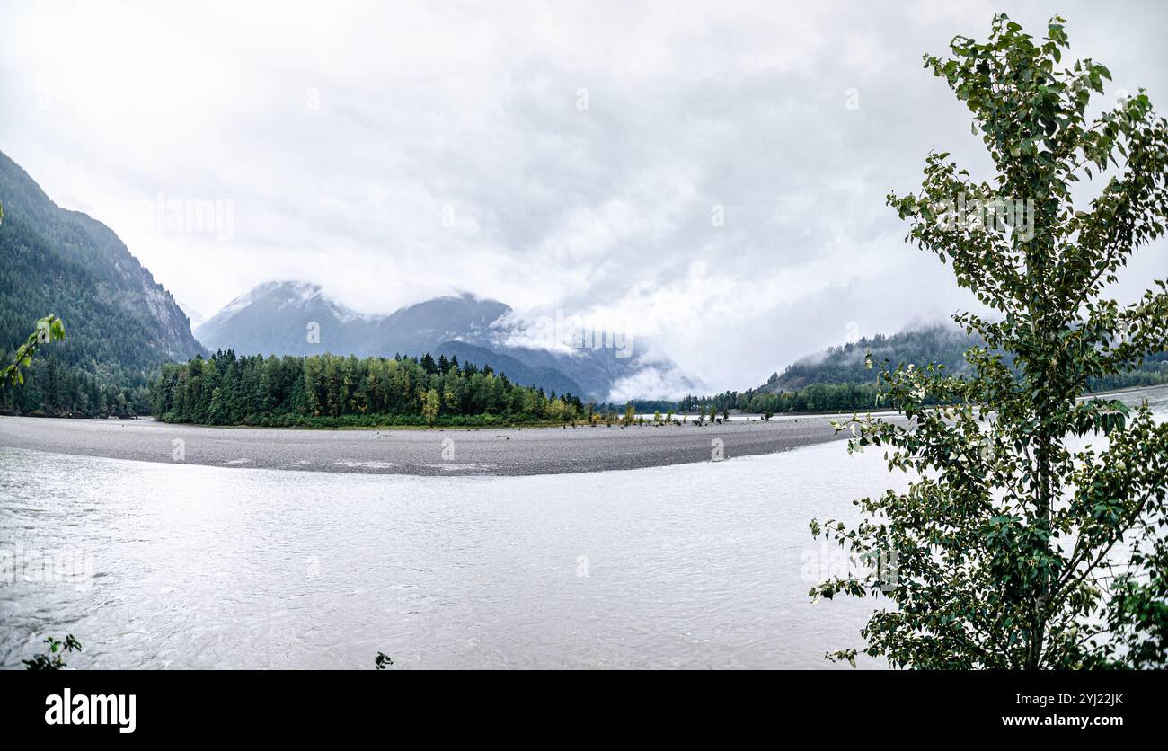 Fraser River with cloud covered green mountains in the background at ...