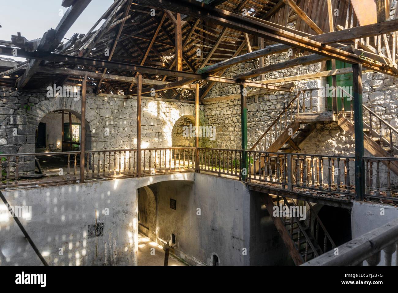 Interior of an old abandoned winery. Stone walls, wooden railings and ...