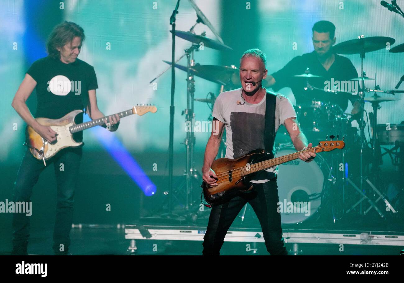 Sting performs with guitarist Dominic Miller, left, and drummer Chris ...