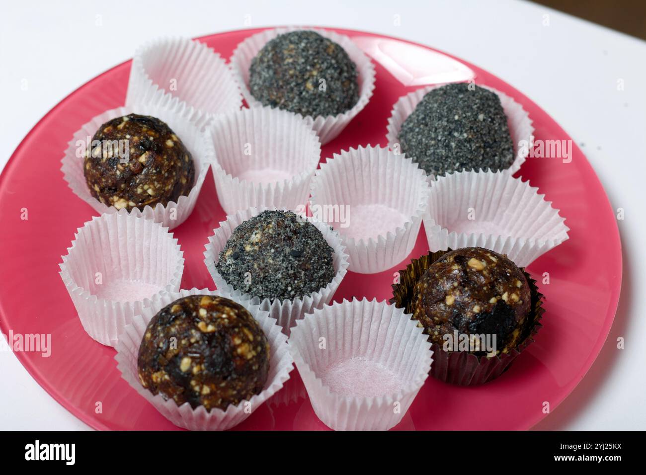 Dried fruit sweets. Balls of prunes, dates and coconut. With a sprinkle ...