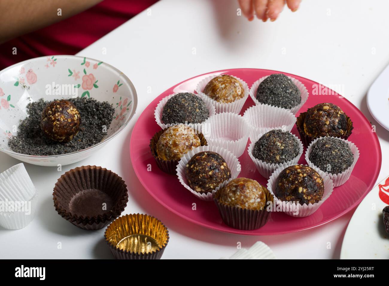 Dried fruit sweets. Balls of prunes, dates and coconut. With a sprinkle ...