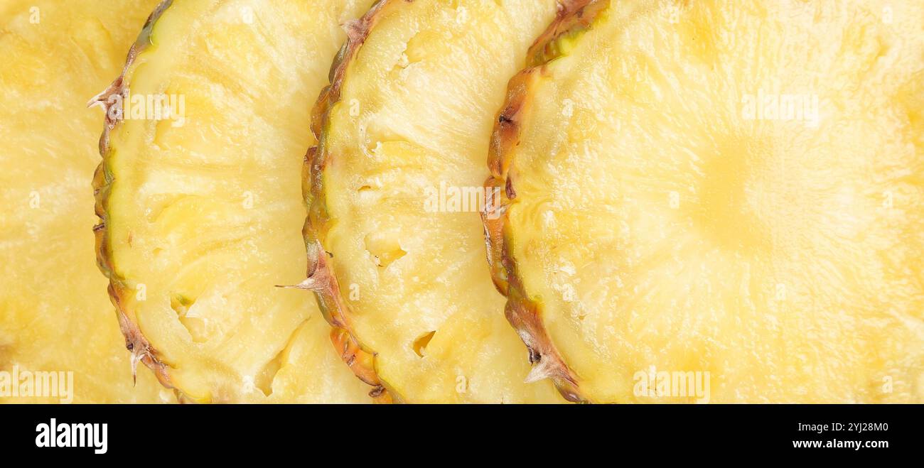 Row sliced pineapple. Close up. Whole background Stock Photo - Alamy
