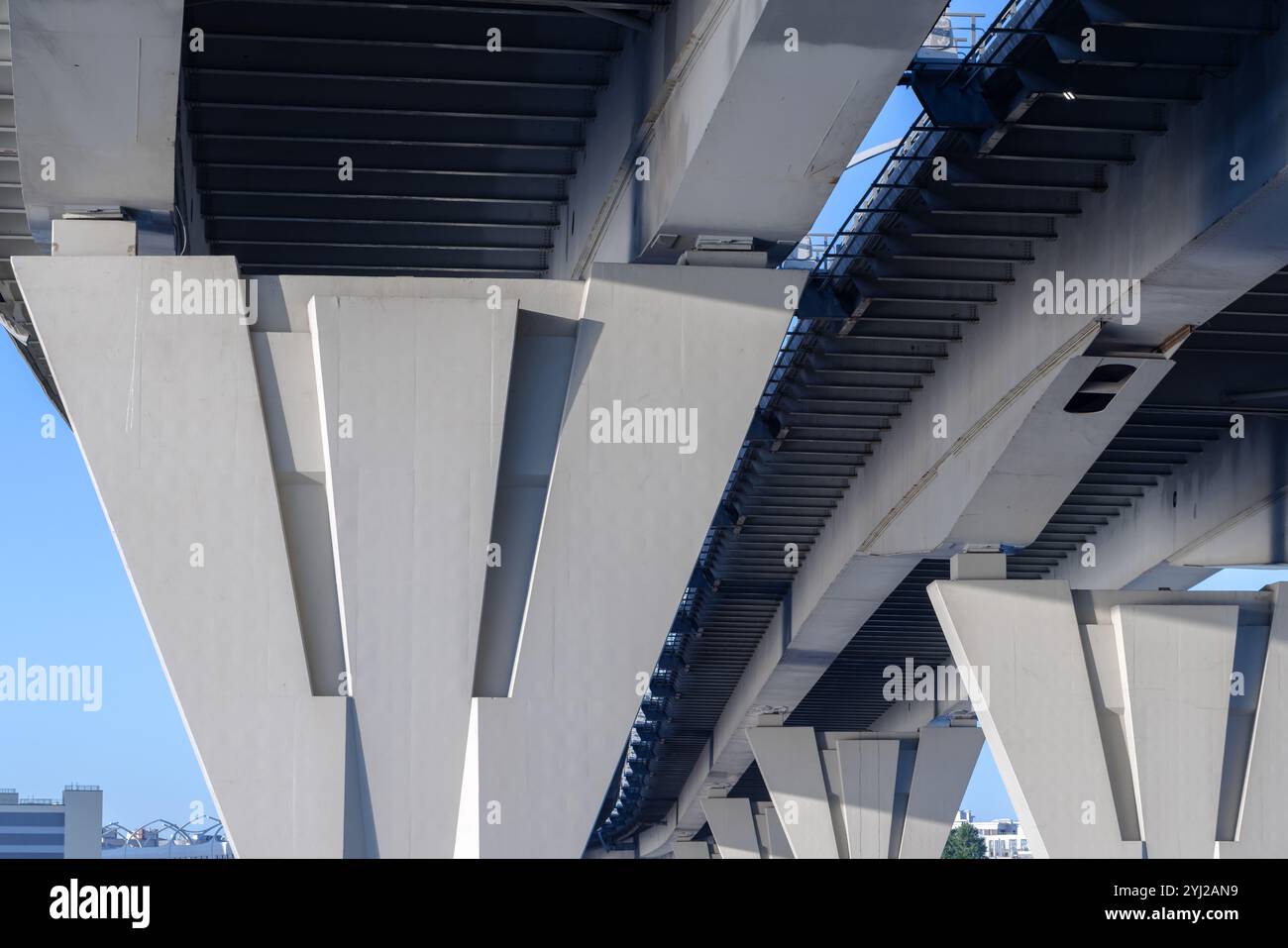Bottom view of a road bridge with concrete pillars. Details of the ...