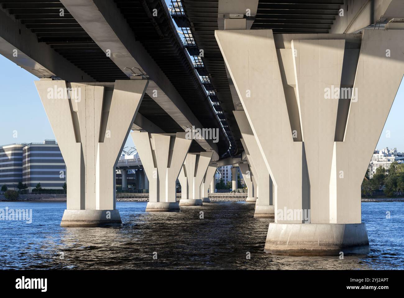 Bottom view of metal road bridge with concrete pillars, a part of the ...