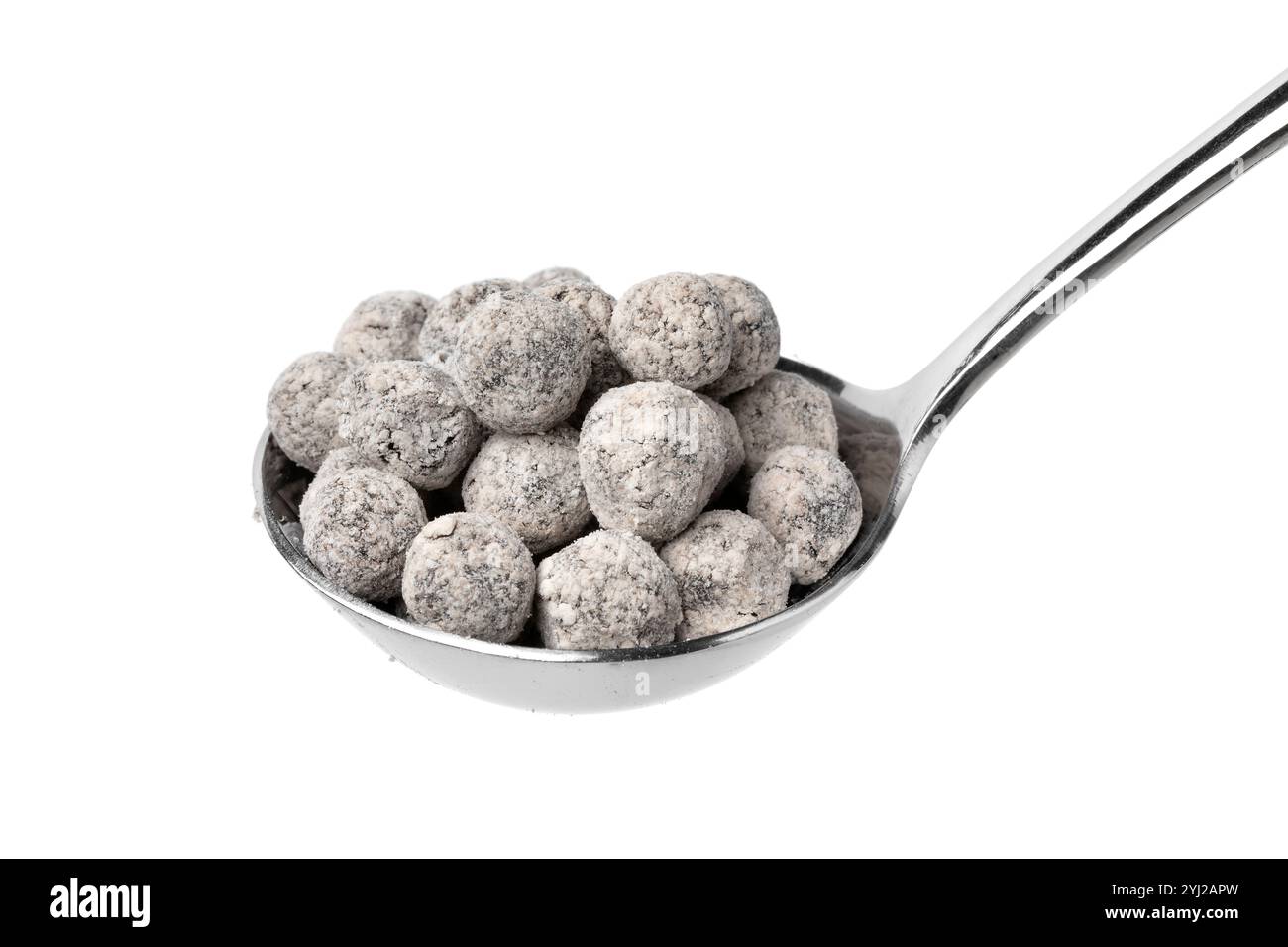Single metal spoon with uncooked black tapioca pearls on white ...