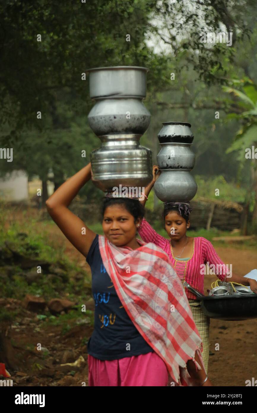 two northeast indian women carrying vessels in head Stock Photo - Alamy