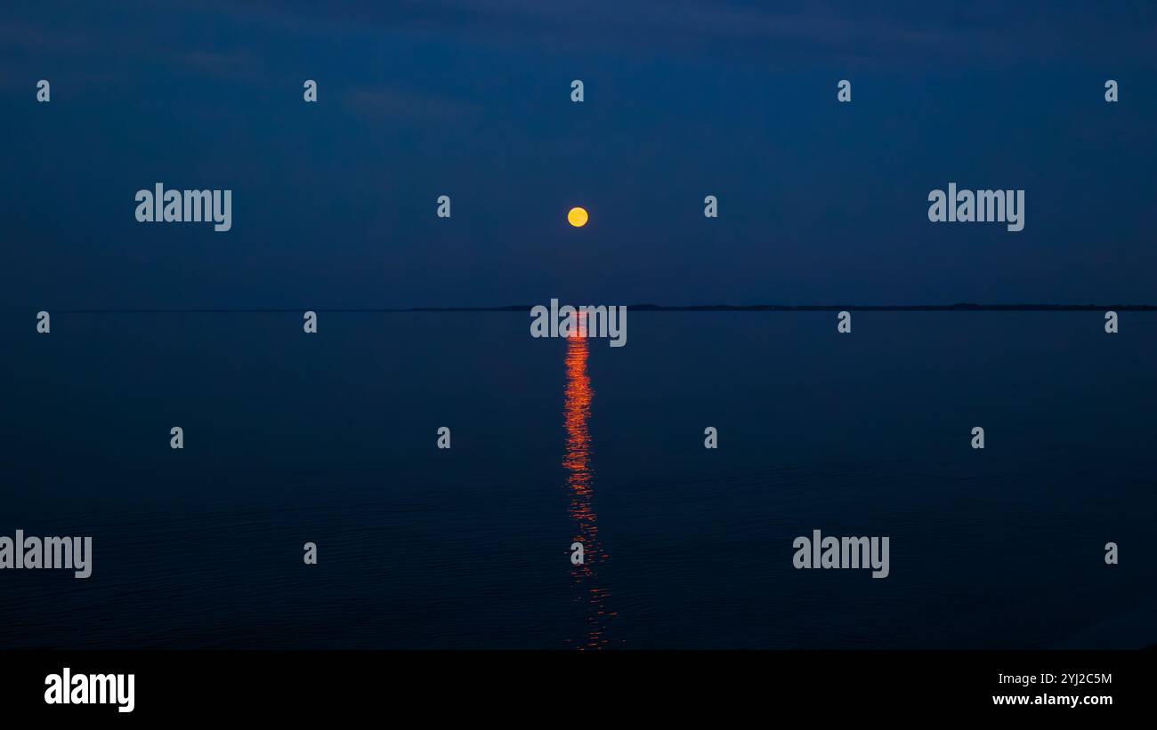Full moon over the sea at night. View of the Ukrainian Black Sea. A ...