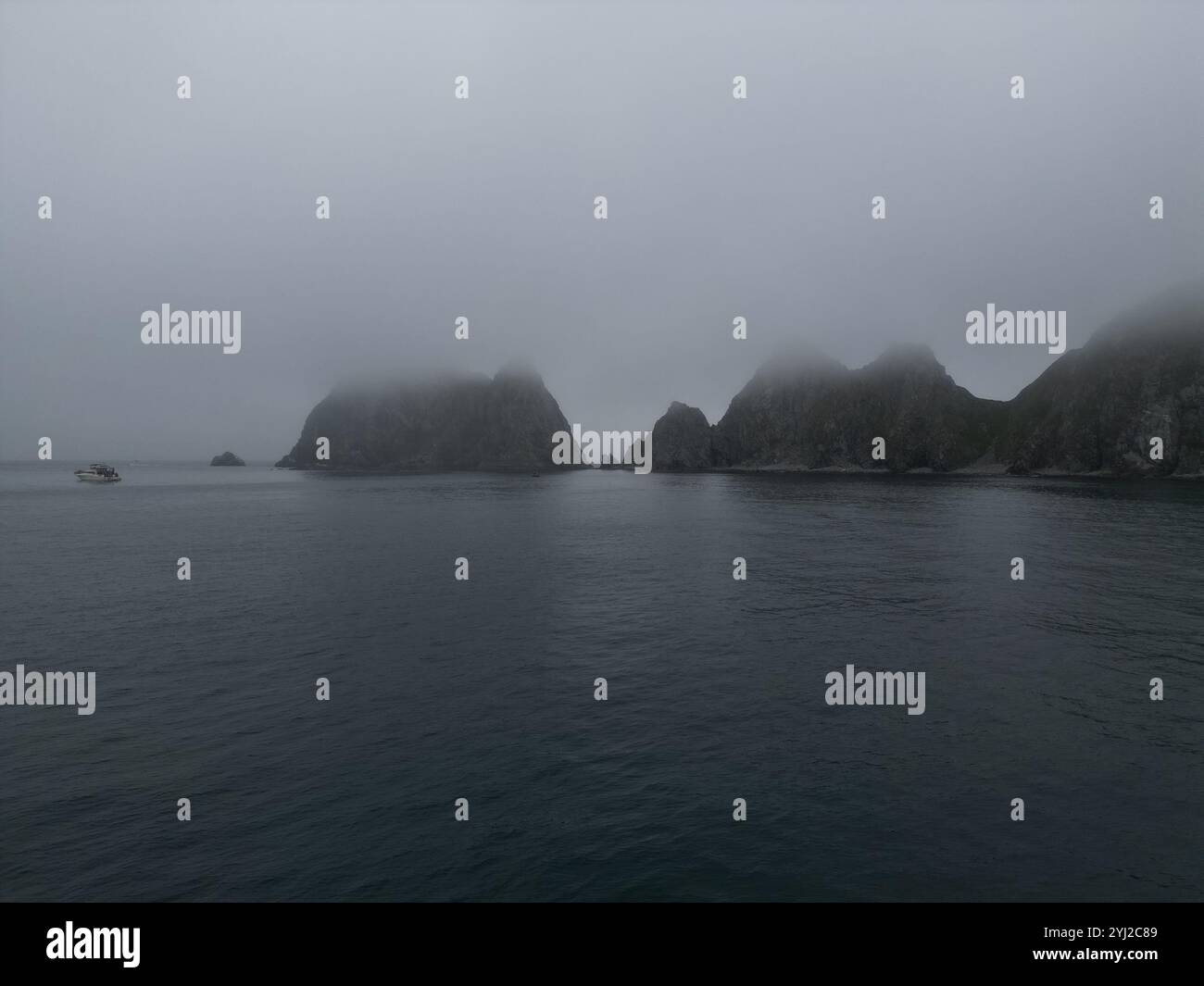 A beautiful and atmospheric misty seascape featuring rocky islands ...