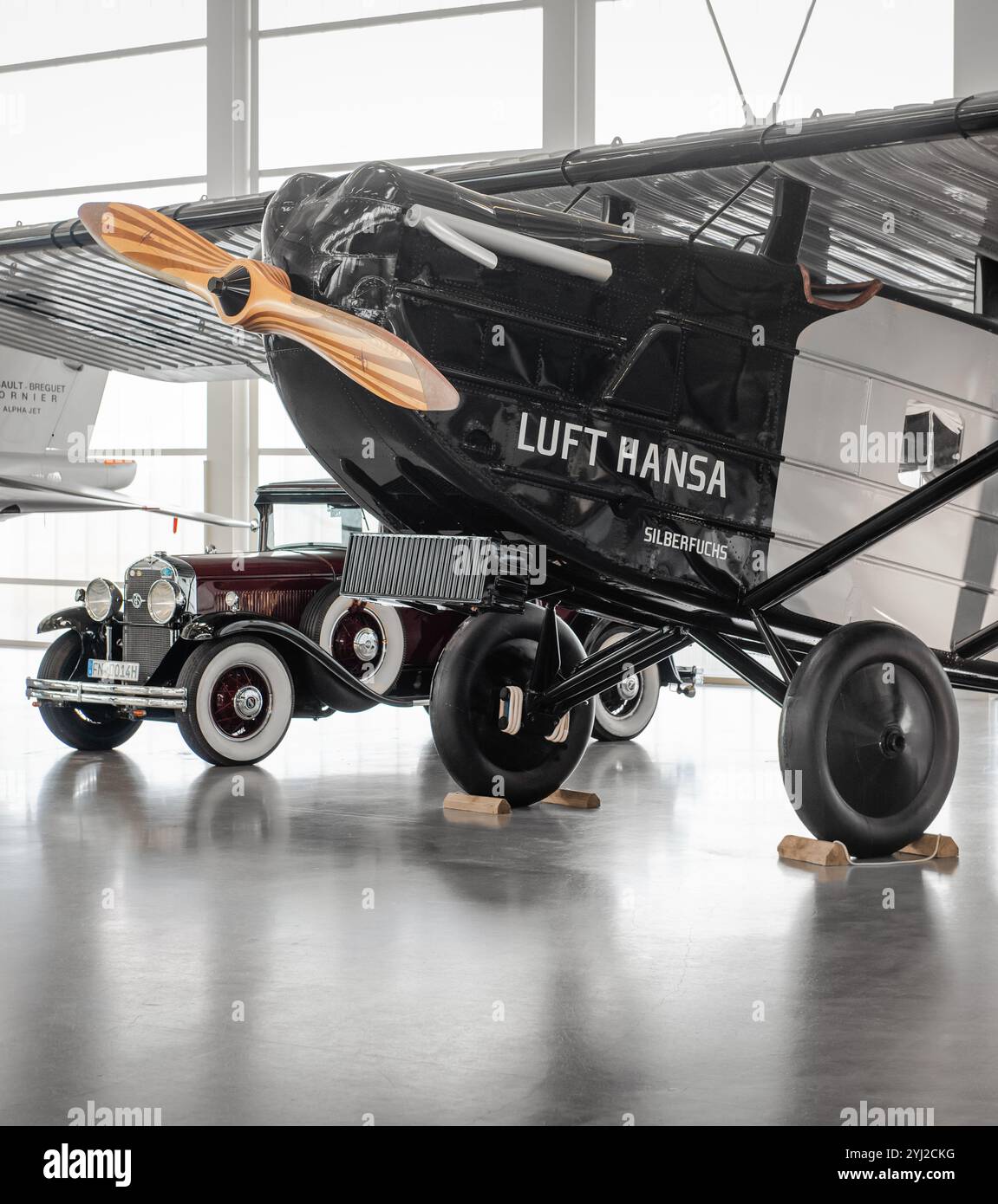 Vintage car in a hangar near 1920s Lufthansa of aircraft. 1930 LaSalle ...