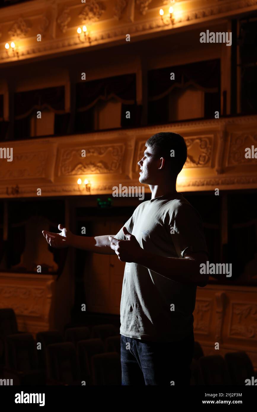 Professional actor rehearsing on stage in theatre Stock Photo - Alamy