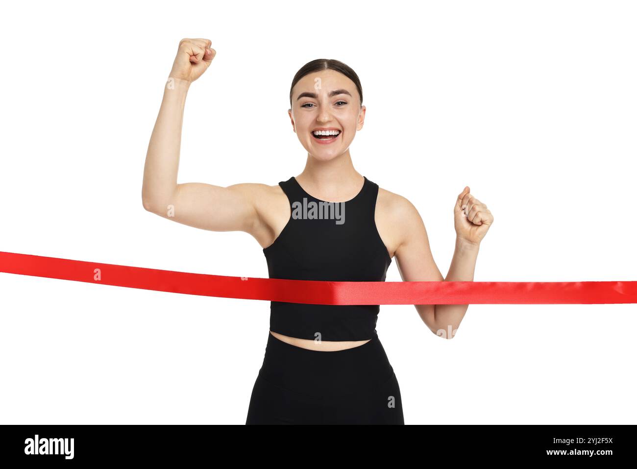 Beautiful woman in sportswear crossing red finish line on white ...