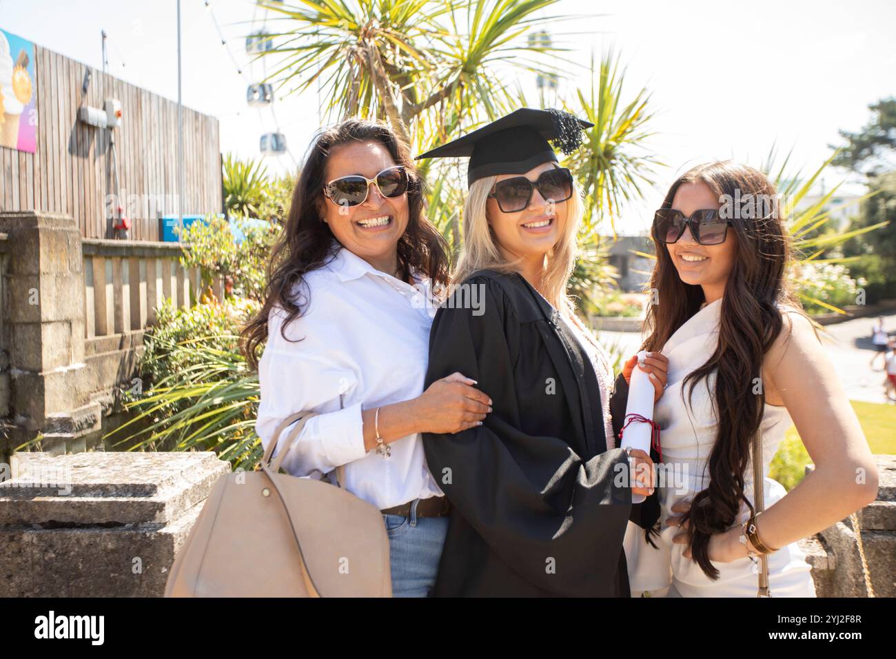 One cap gown holding diploma hi-res stock photography and images - Alamy