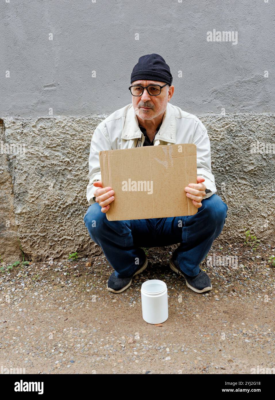 Man wall squatting hi-res stock photography and images - Alamy