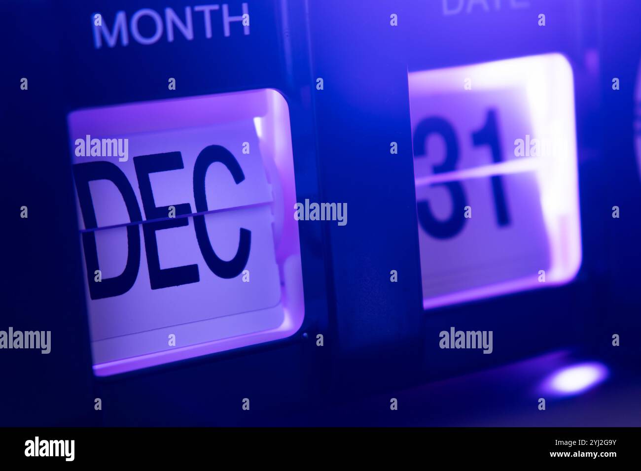 December 31st on flip calendar clock in purple light Stock Photo - Alamy