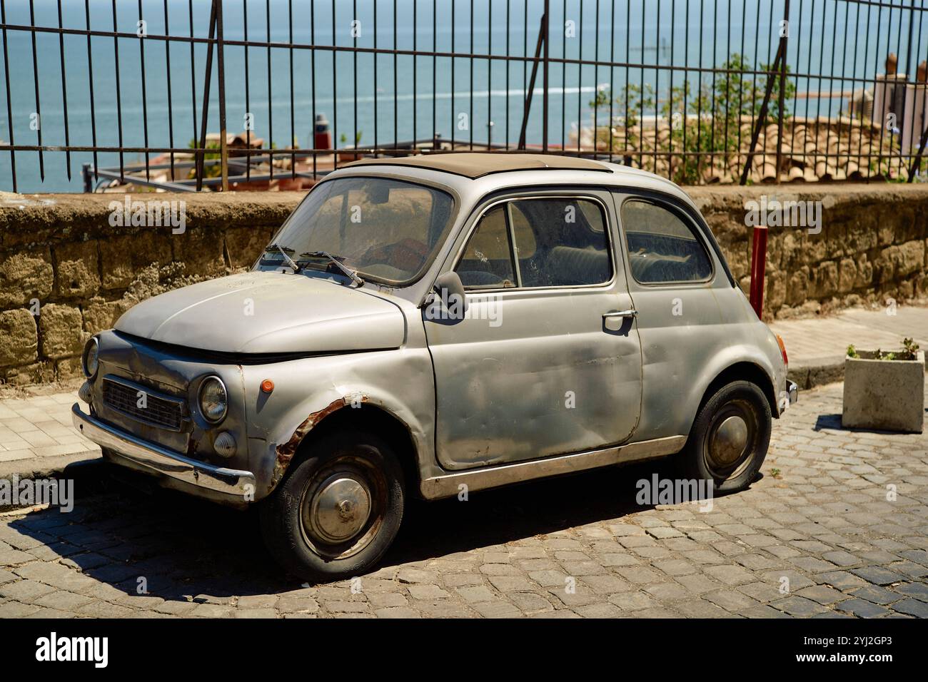 Vintage small car parked seaside fence under clear sky hi-res stock ...