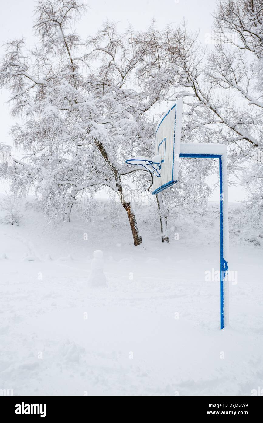 Street basketball ring on a frosty winter morning, out of season. A ...