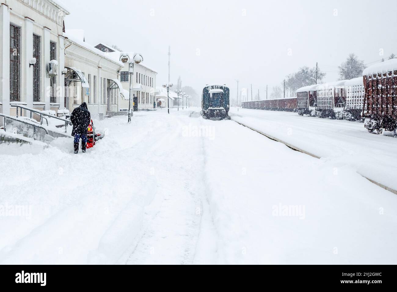 Railway station platform during heavy snowfall. Railway station in ...