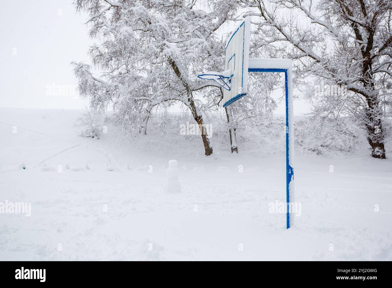 Street basketball ring on a frosty winter morning, out of season. A ...
