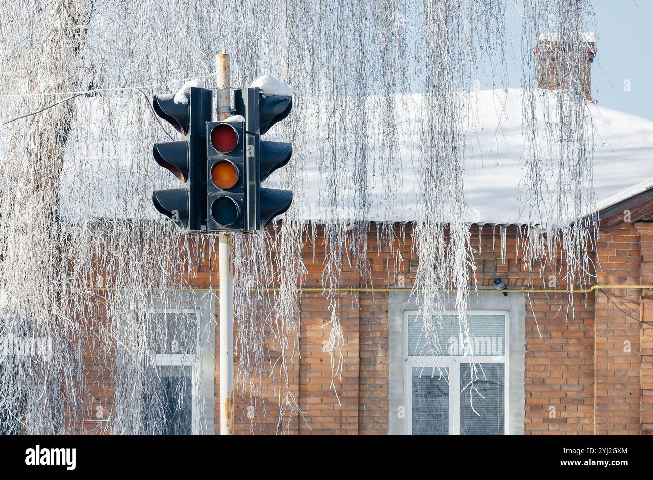 A traffic light on a metal pole against the background of urban ...