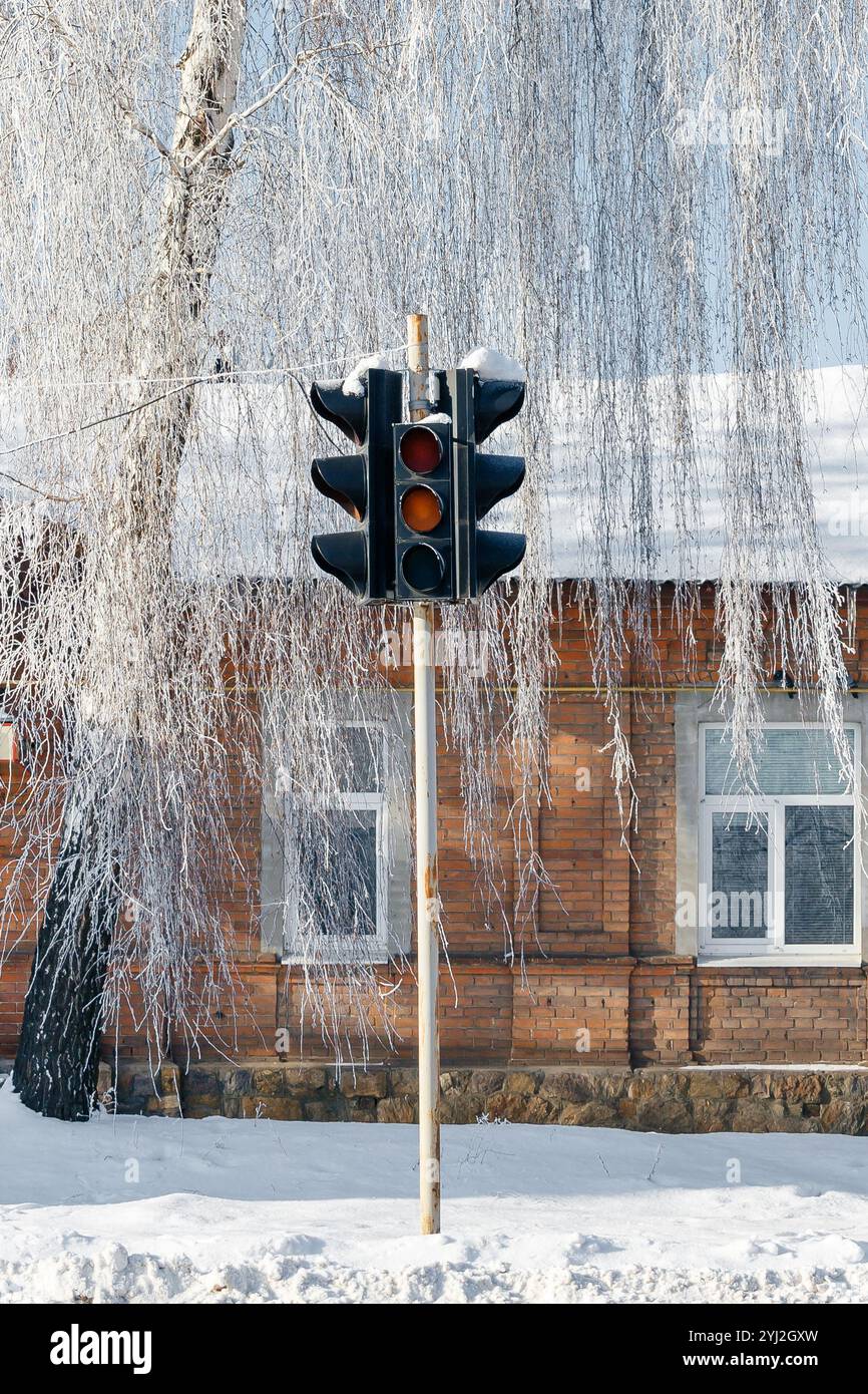 A traffic light on a metal pole against the background of urban ...