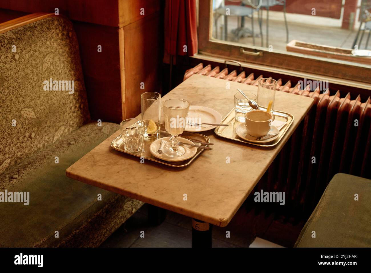 A cozy retro vintage coffee table setup with finished drinks and open ...