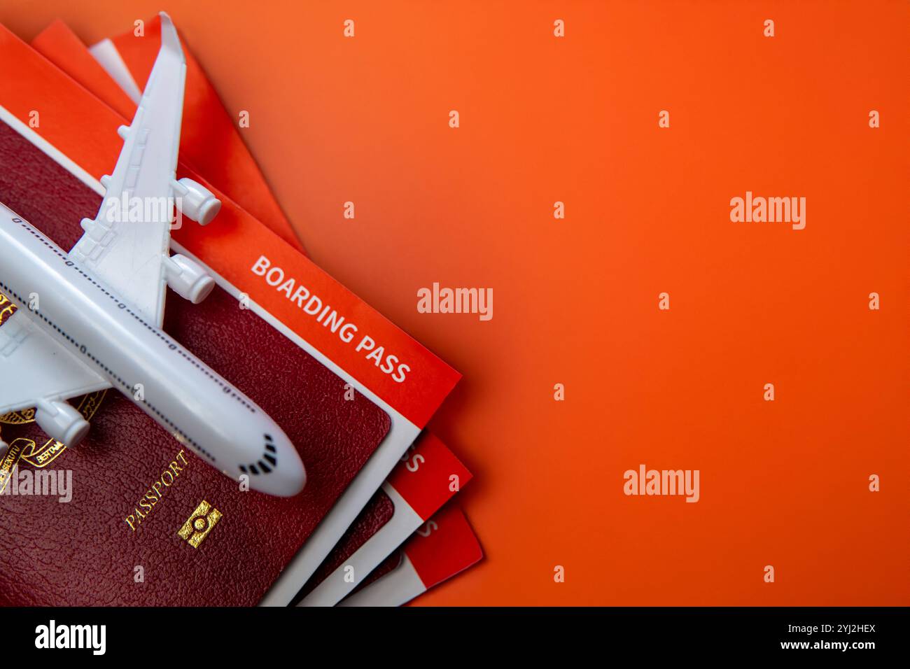Top view image of passport with boarding passes and a toy airplane on a ...