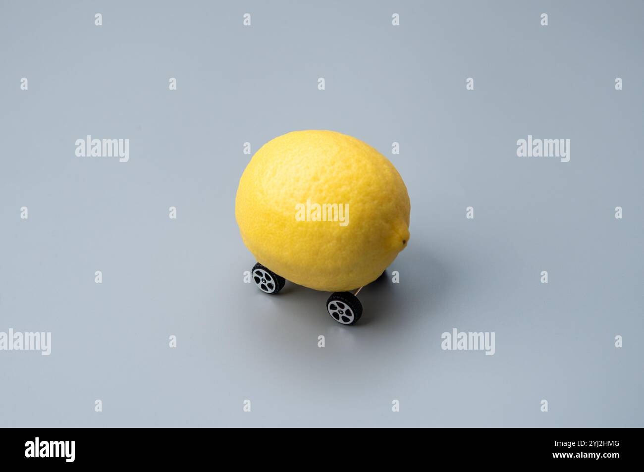 A lemon with small wheels attached to it. Lemon car, defect or ...