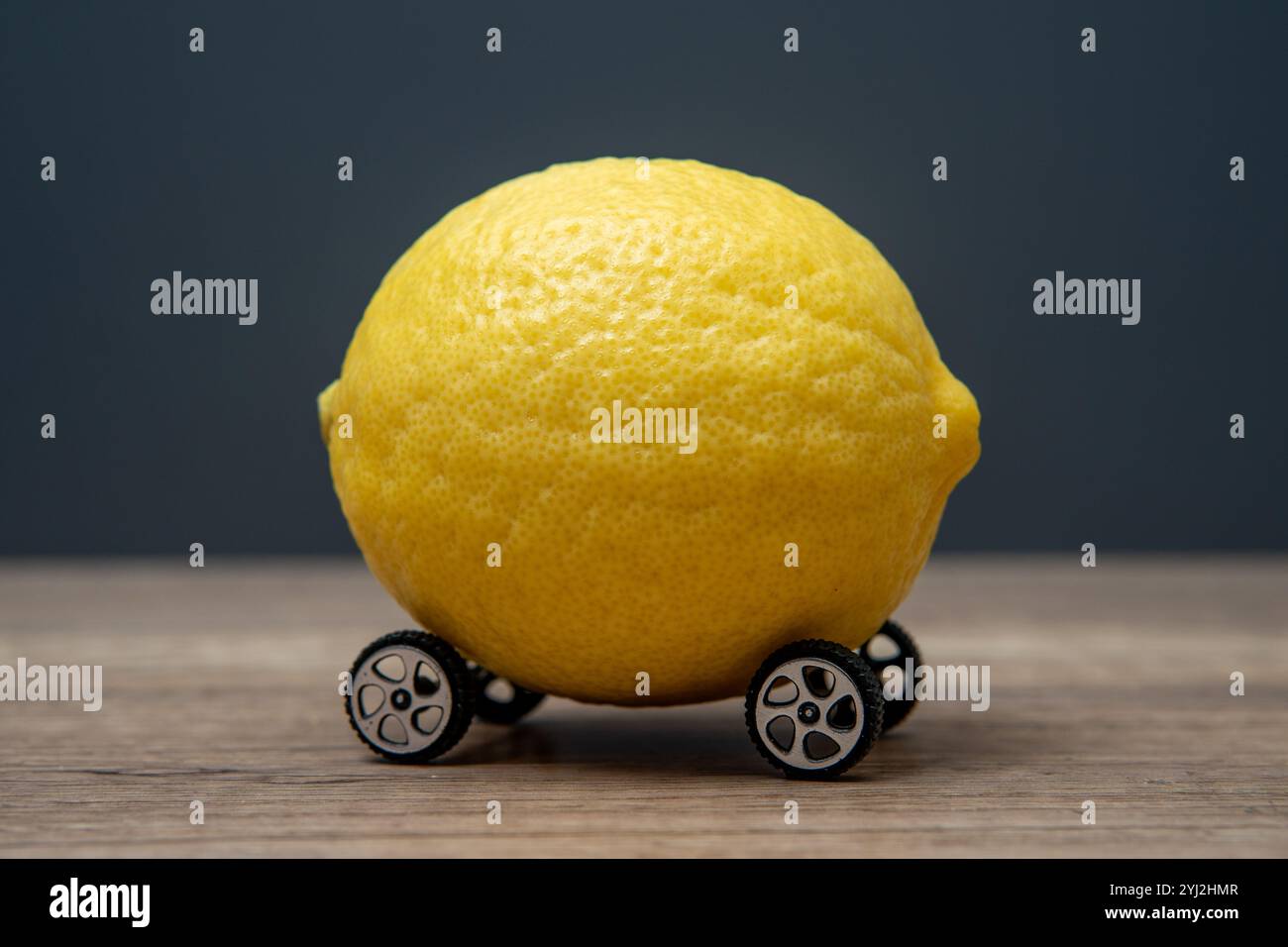 A lemon with small wheels attached to it. Lemon car, defect or ...