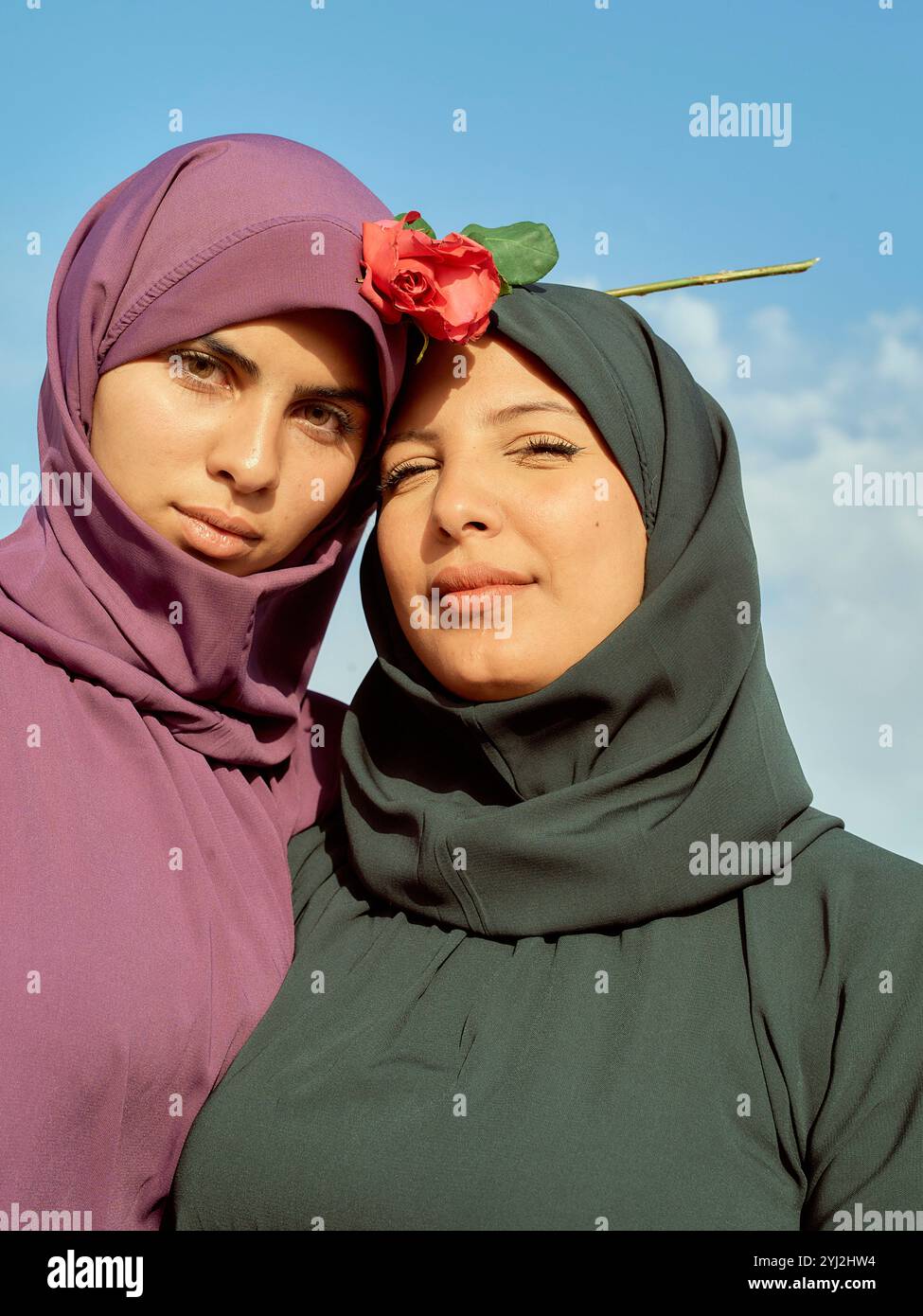 Two women hijabs posing clear sky hi-res stock photography and images ...